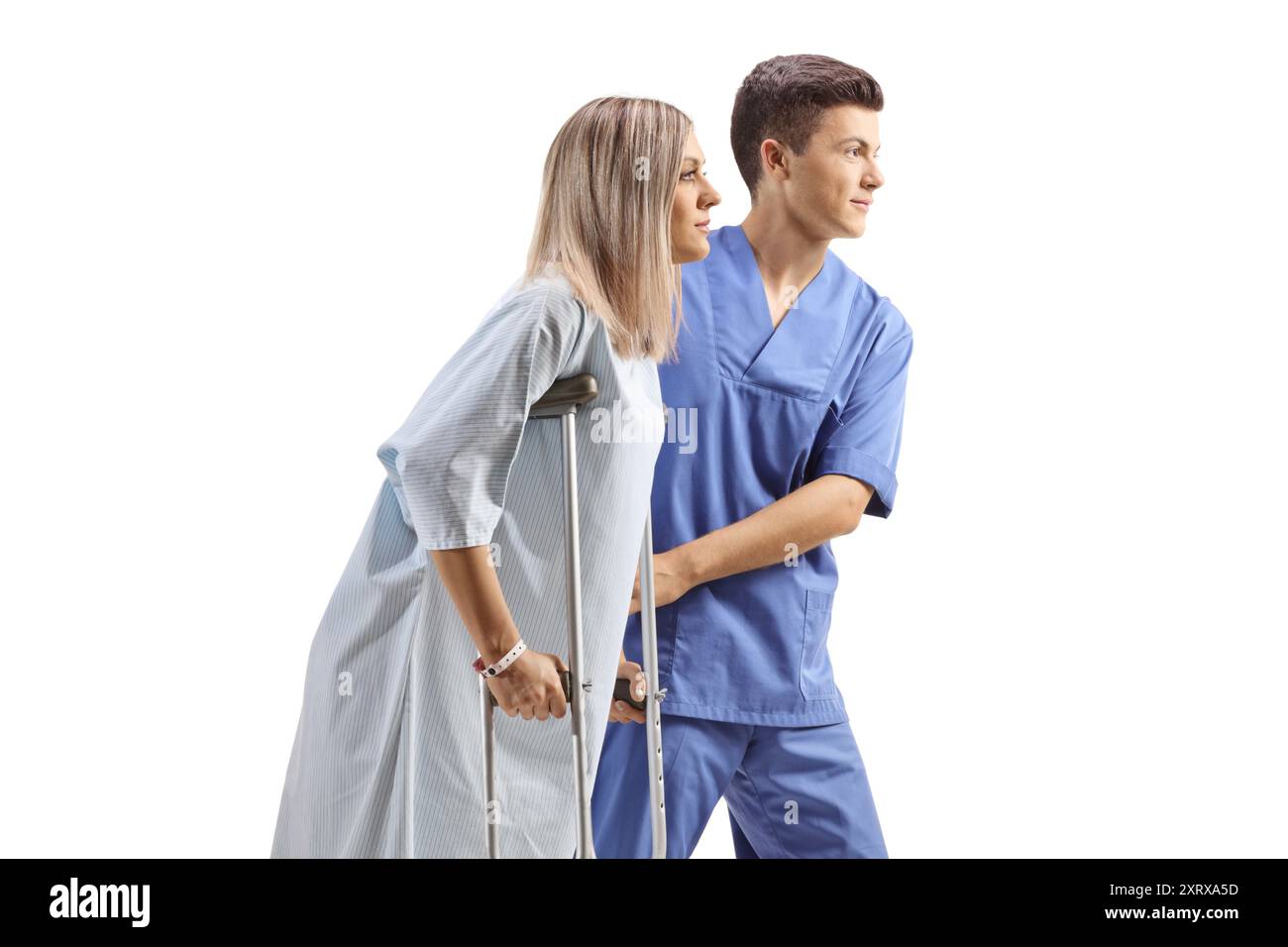 Health care worker helping a female patient with crutches isolated on ...