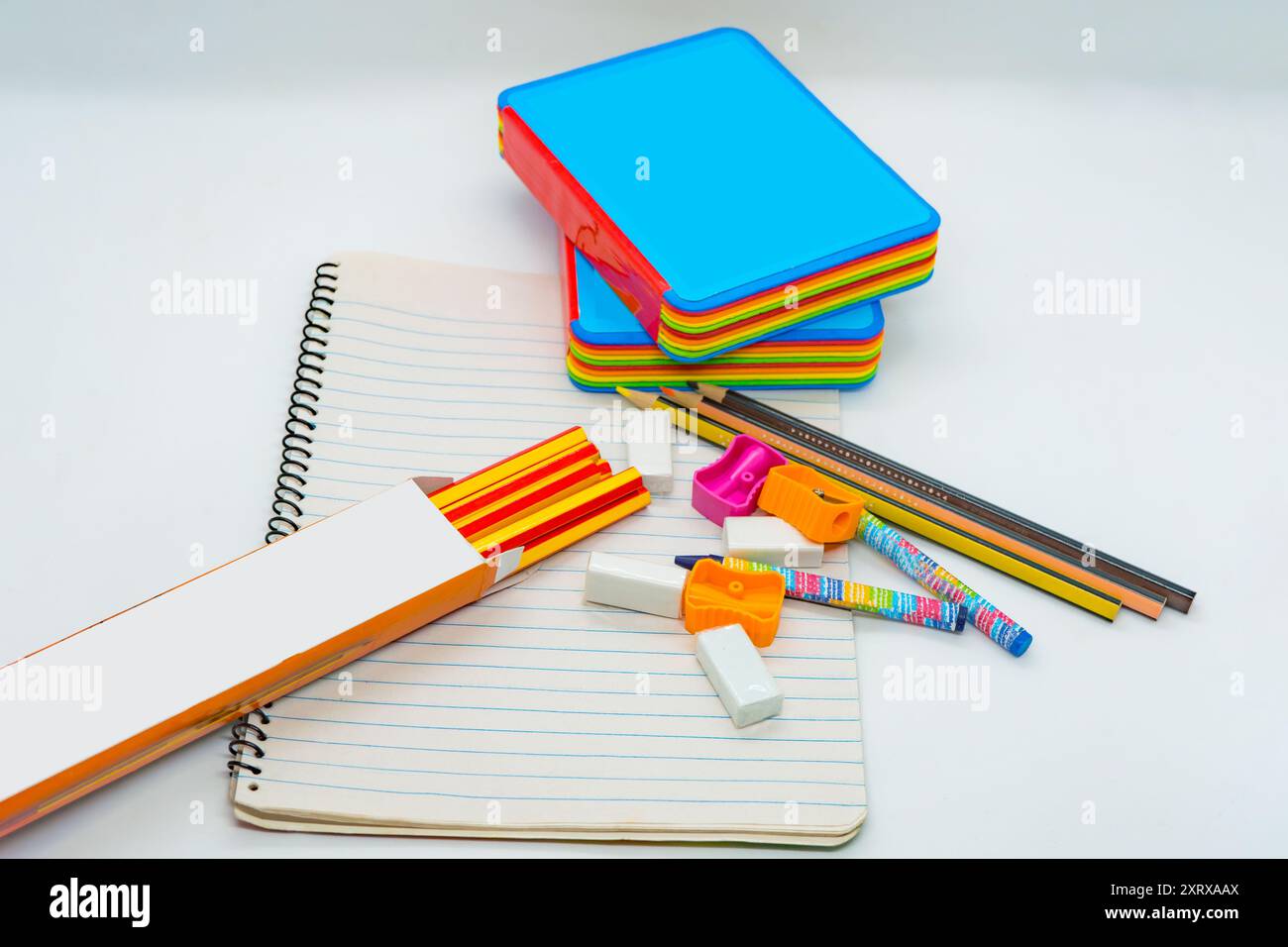 a stack of pencils, pens, and pencils are on a notebook with color book ...