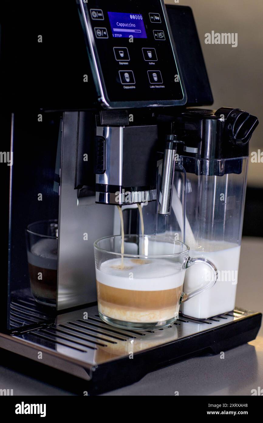 Modern coffee machine with glass cup of latte in kitchen Stock Photo ...