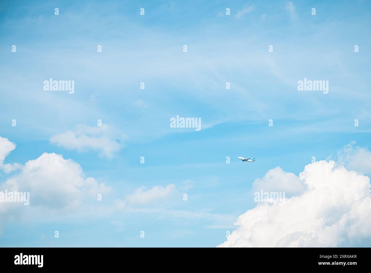 A white plane in the sky with beautiful white clouds. Travel, Flight ...