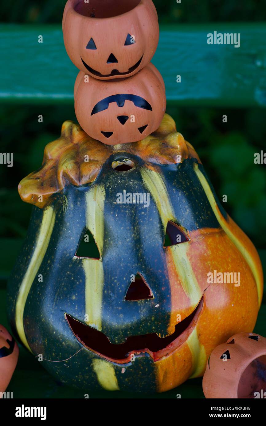 Clay pumpkins on a park bench having fun Stock Photo - Alamy