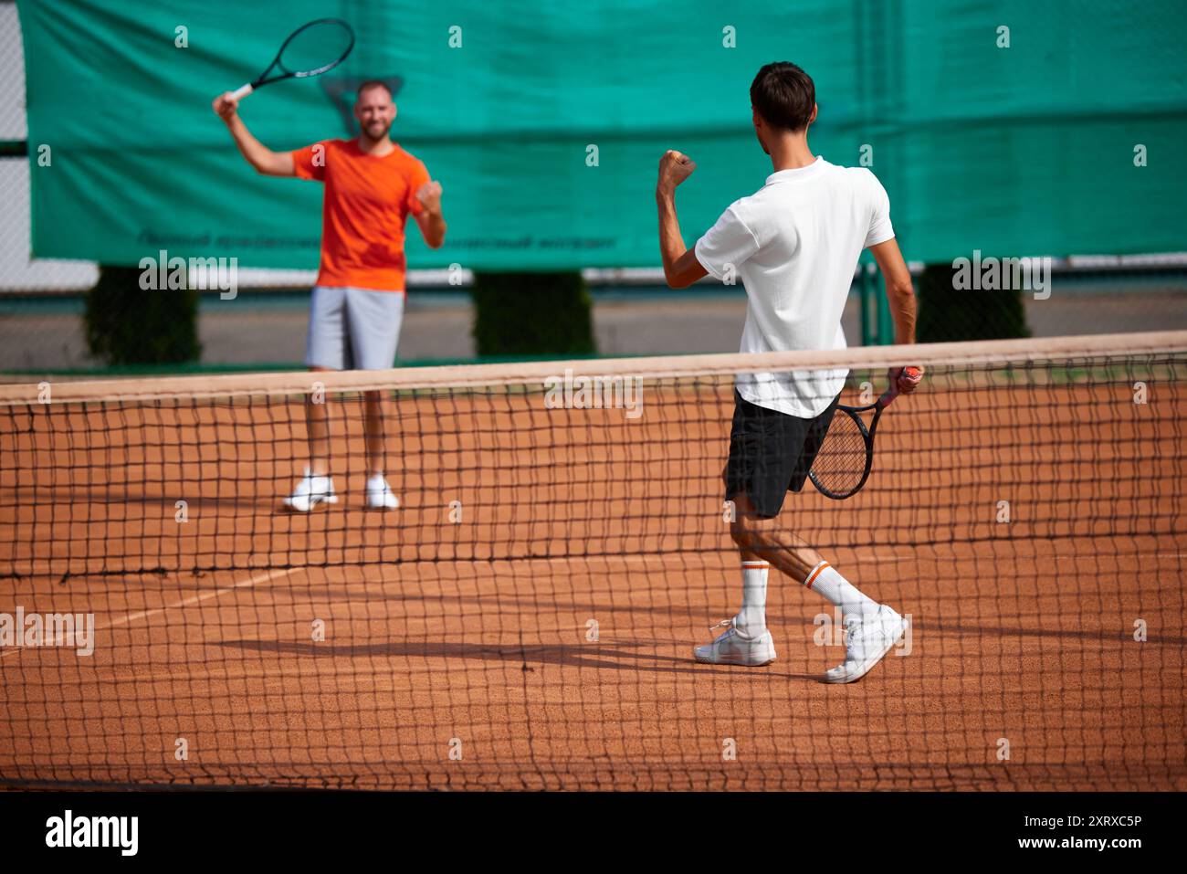 Two men, friends, tennis player showing gesture of victory after ...
