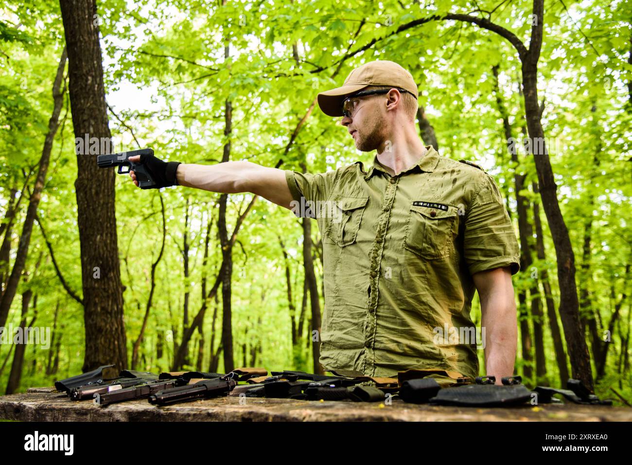 the guy in the woods is cleaning his weapon Stock Photo - Alamy