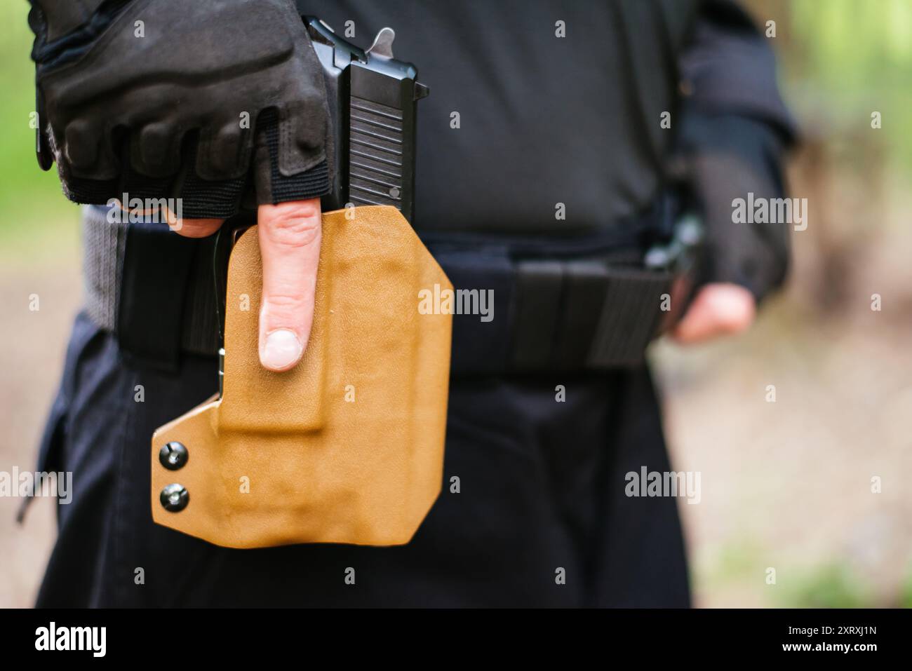 the guy puts the gun in the holster Stock Photo - Alamy