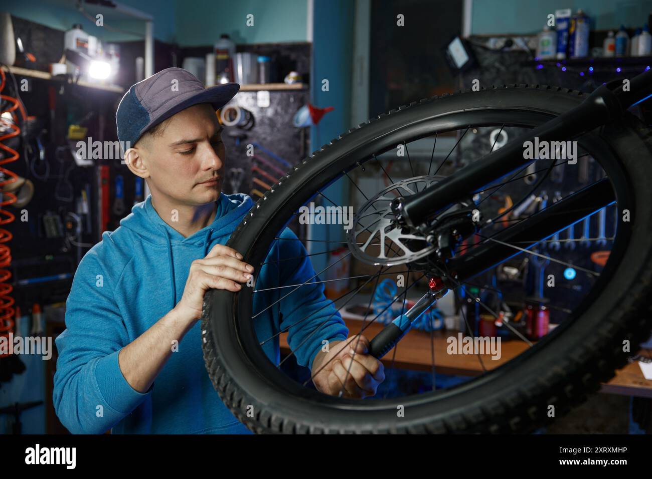 Mechanic using screwdriver repairing bicycle hi-res stock photography ...