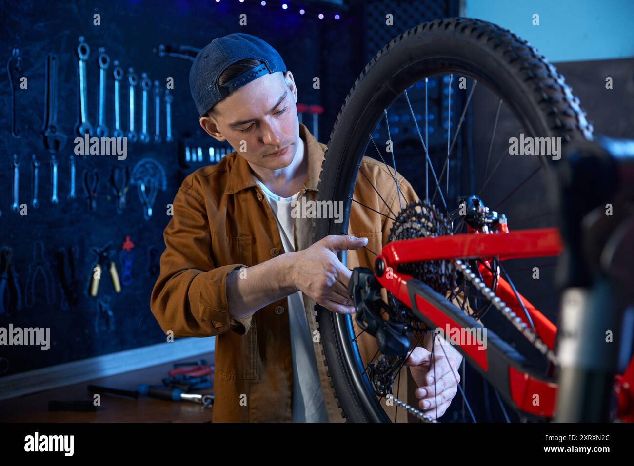 Mechanic man working bicycle wheel checking correct rim alignment Stock ...