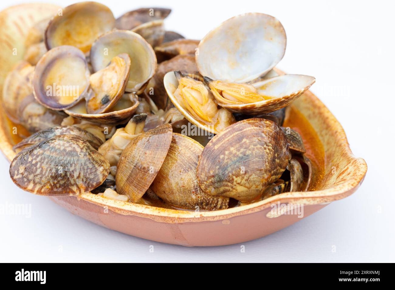 Close up of a Clams in marinera sauce appetizer on white background, a ...