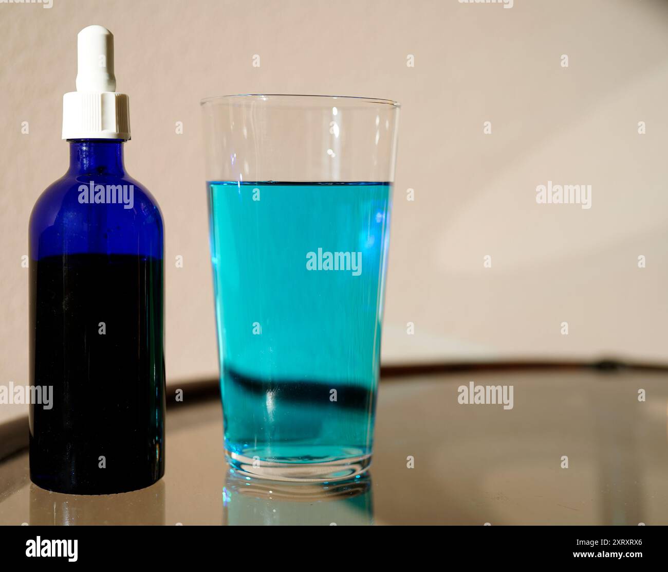 image showing a bottle filled with methylene blue near a glass with ...