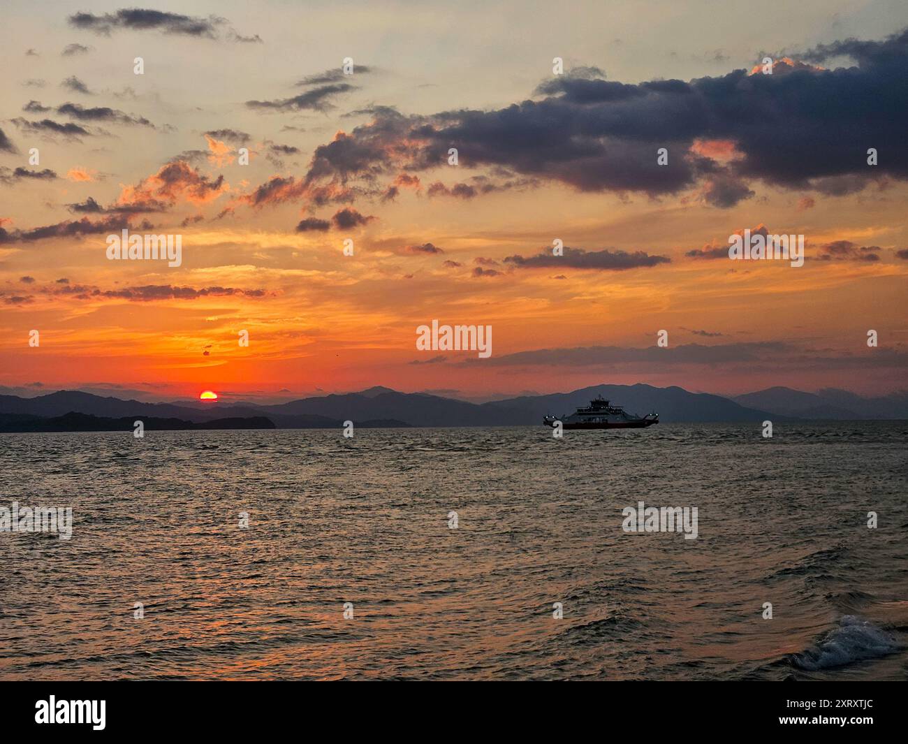 A scenic view of sunset over a calm sea in Puntarenas, Costa Rica Stock ...