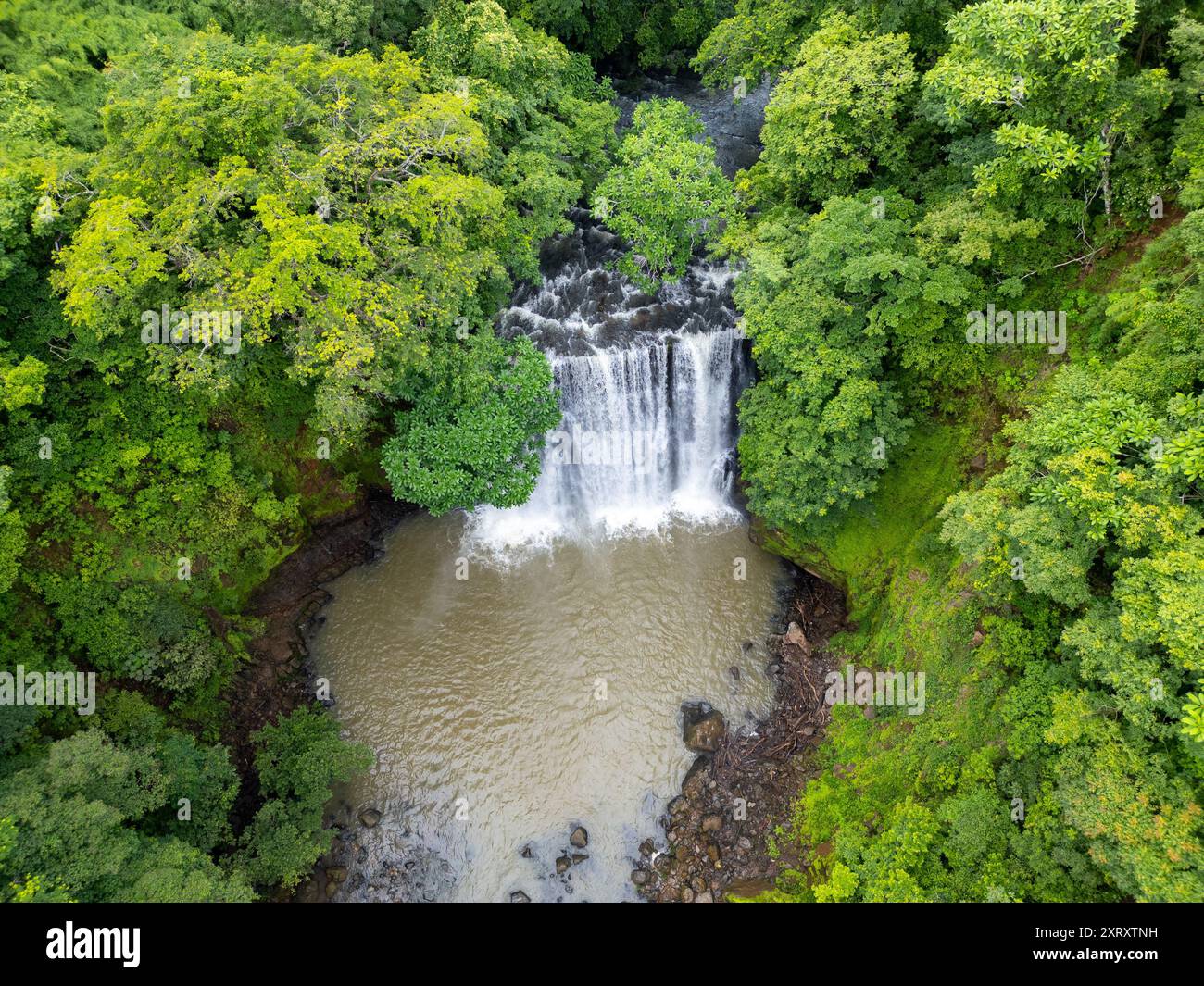 An aerial view of El Encanto Waterfall in lush green forest Stock Photo ...