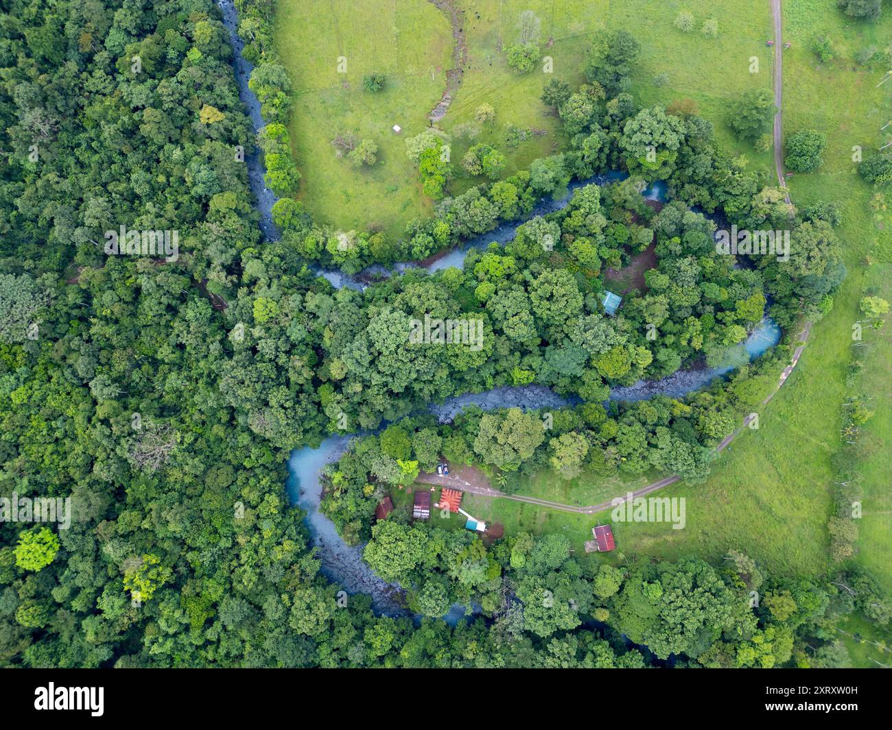 An aerial view of Celeste River through dense green forest in in Costa ...