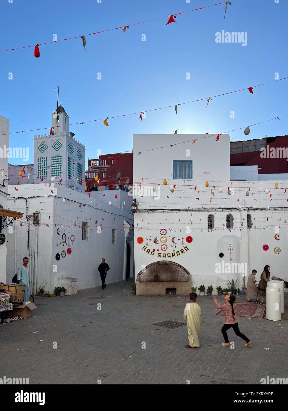 Kids playing in a square of Tangier medina during Eid Mubarak Stock ...