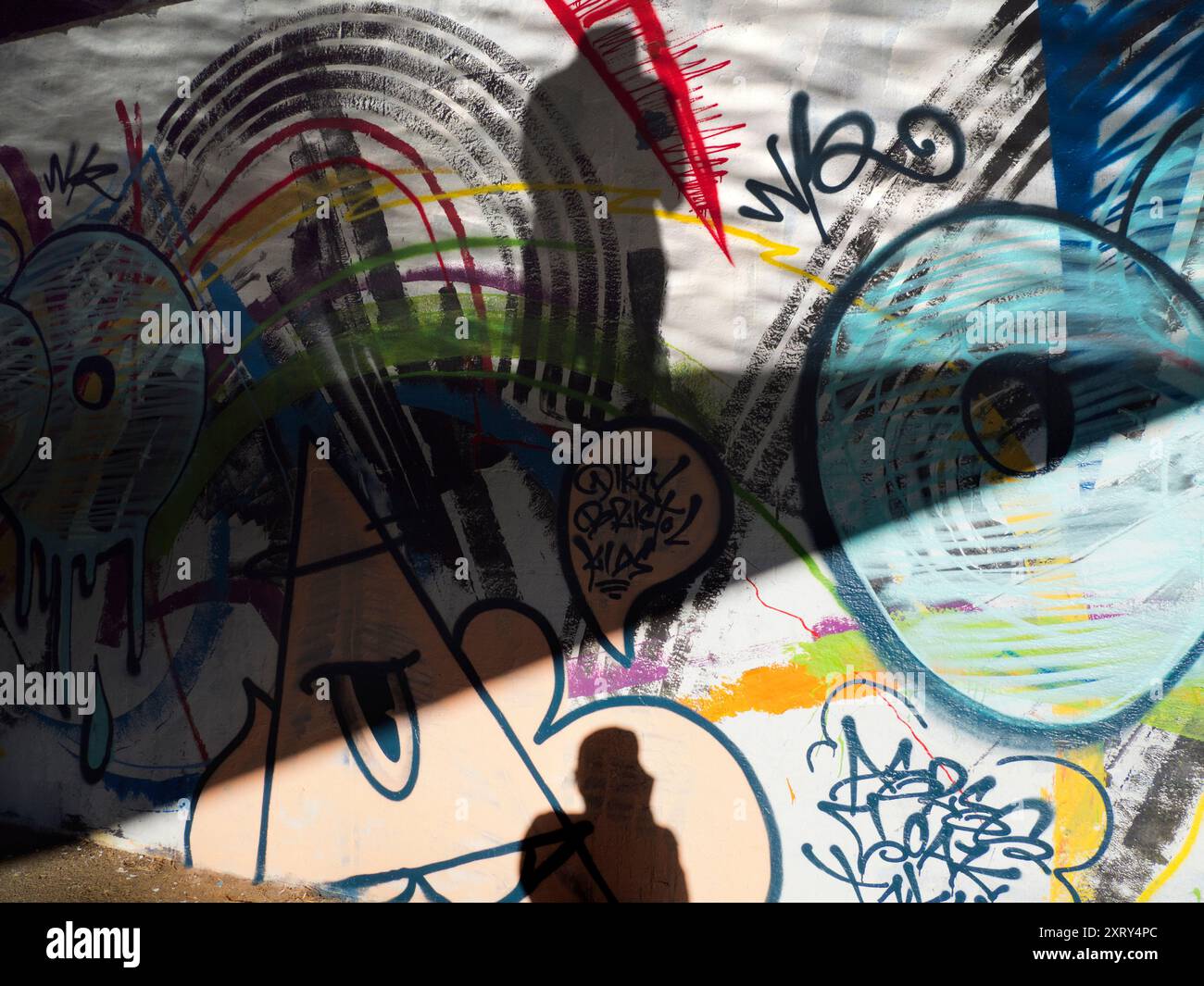 Graffiti and shadows beneath a bridge. Contrasts. This image of ...