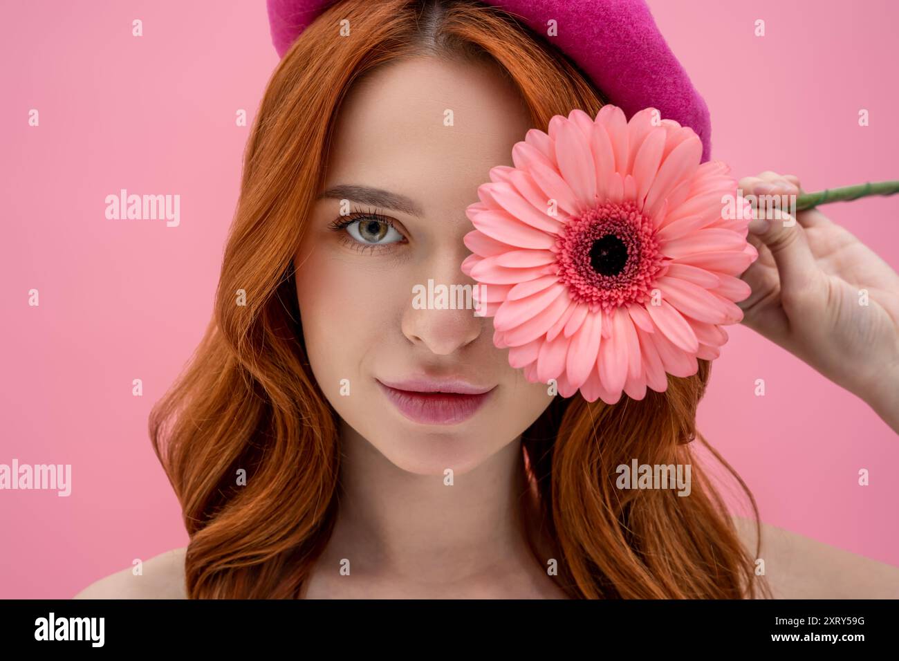 Portrait of a young beautiful ginger woman with a flower in hands Stock ...