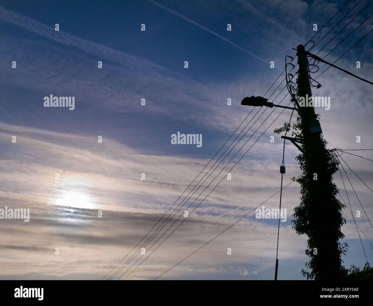 Luminous altocumulus cloudscape and emerging sun over Radley Village. I ...