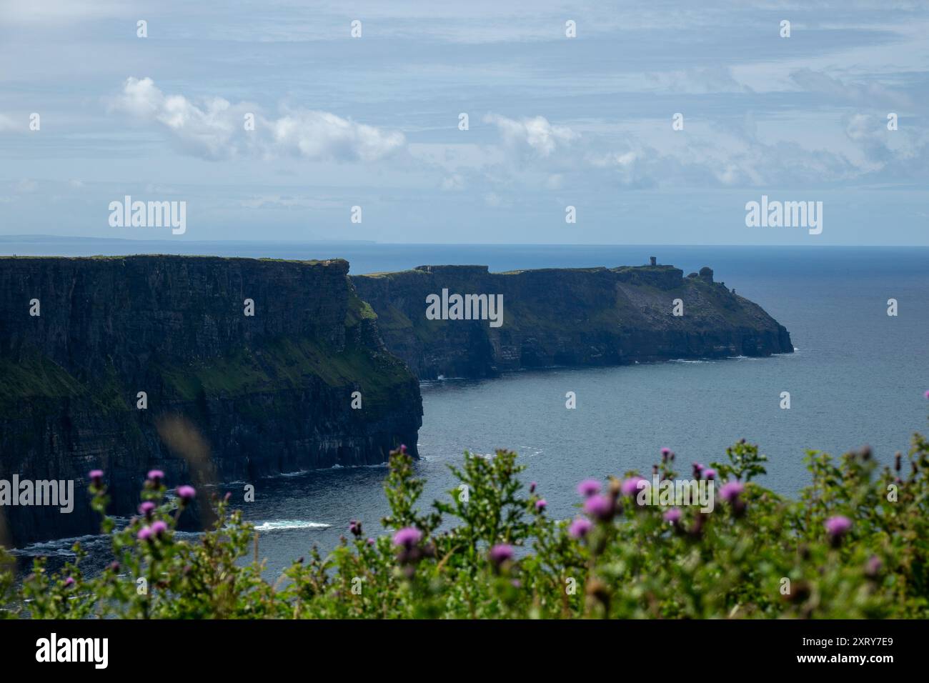 A panoramic view of the towering cliffs of Moher, with rocky outcrops ...