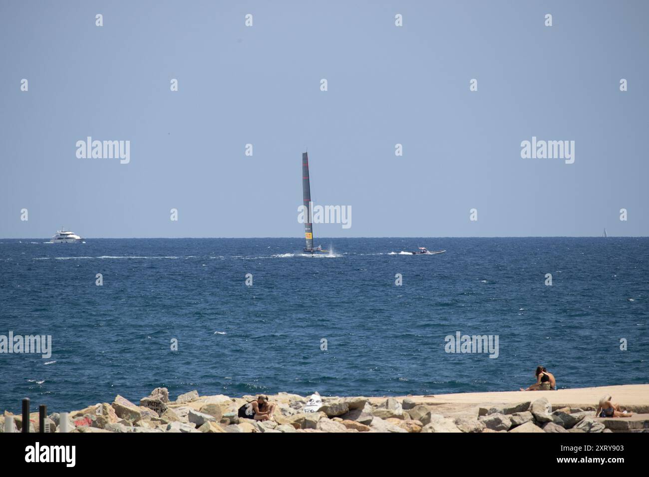 Barcelona, Spain; Jul 2 2024: An hydrofoil AC75 sail ship makes a sharp ...