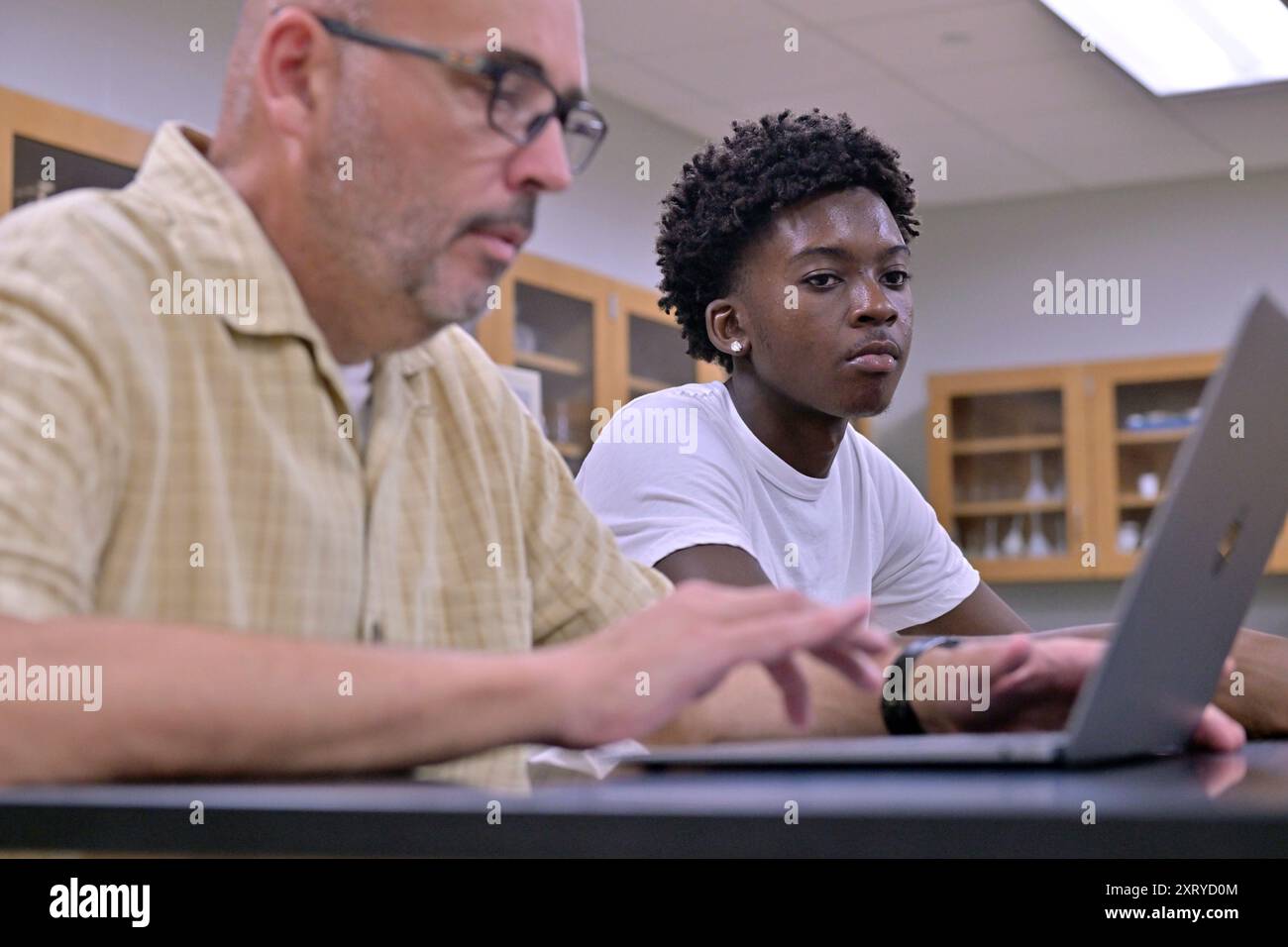 History teacher Matt Brophy, left, works with Flerentin “Flex” Jean ...