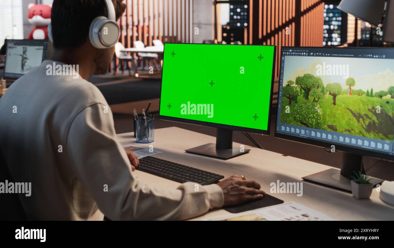 Indian Male Game Designer Using Desktop Computer With Green Screen ...