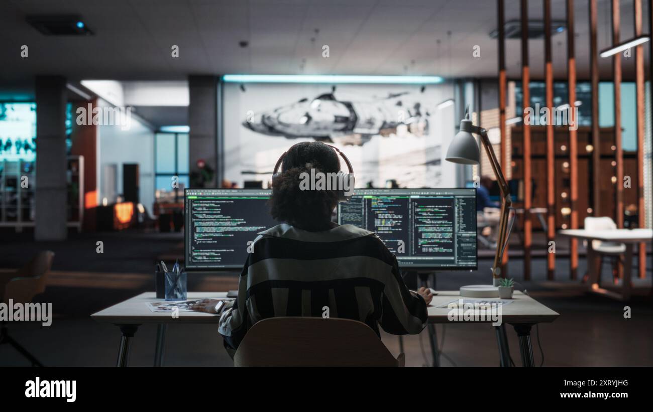 Creative Office: Professional Black Female Programmer Uses Headphones ... Creative Office: Professional Black Female Programmer Uses Headphones ...