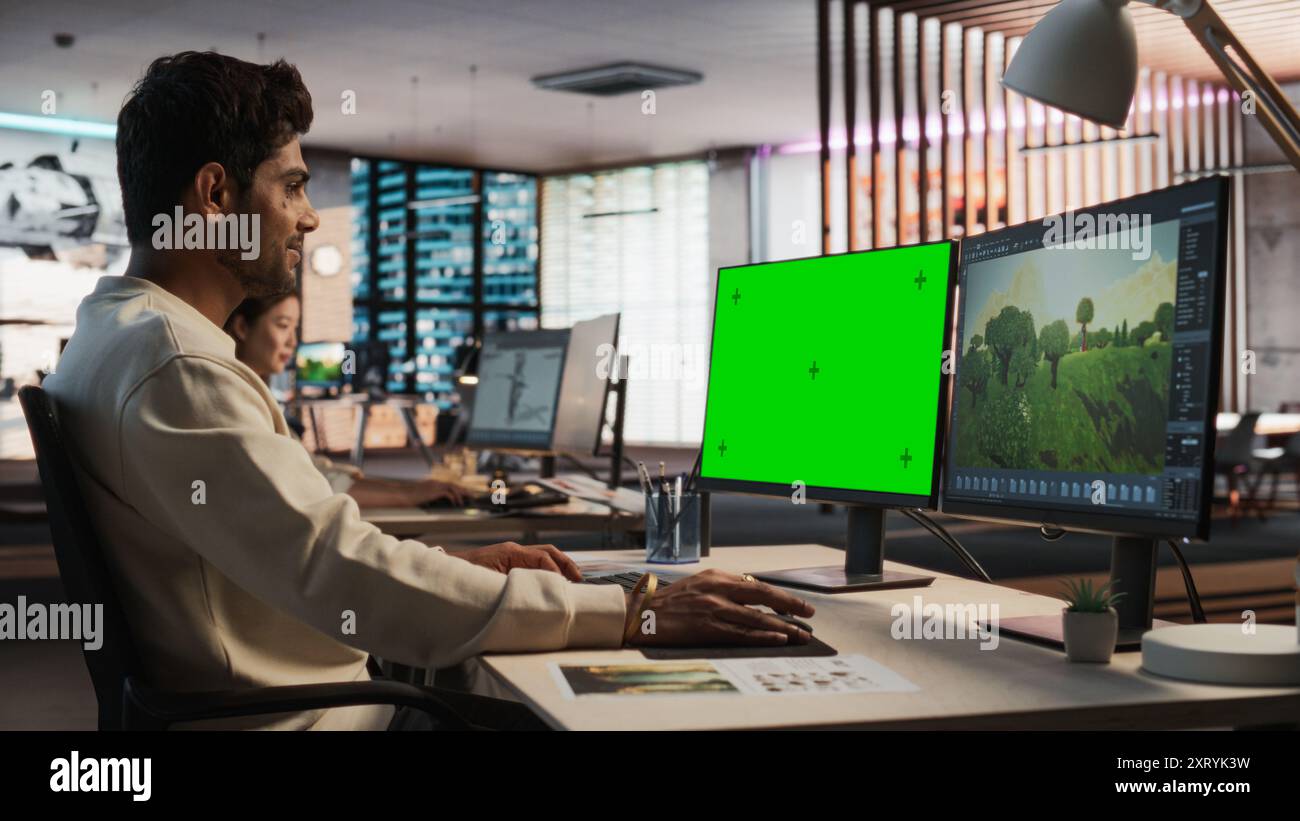 Indian Male Game Designer Using Desktop Computer With Green Screen ...
