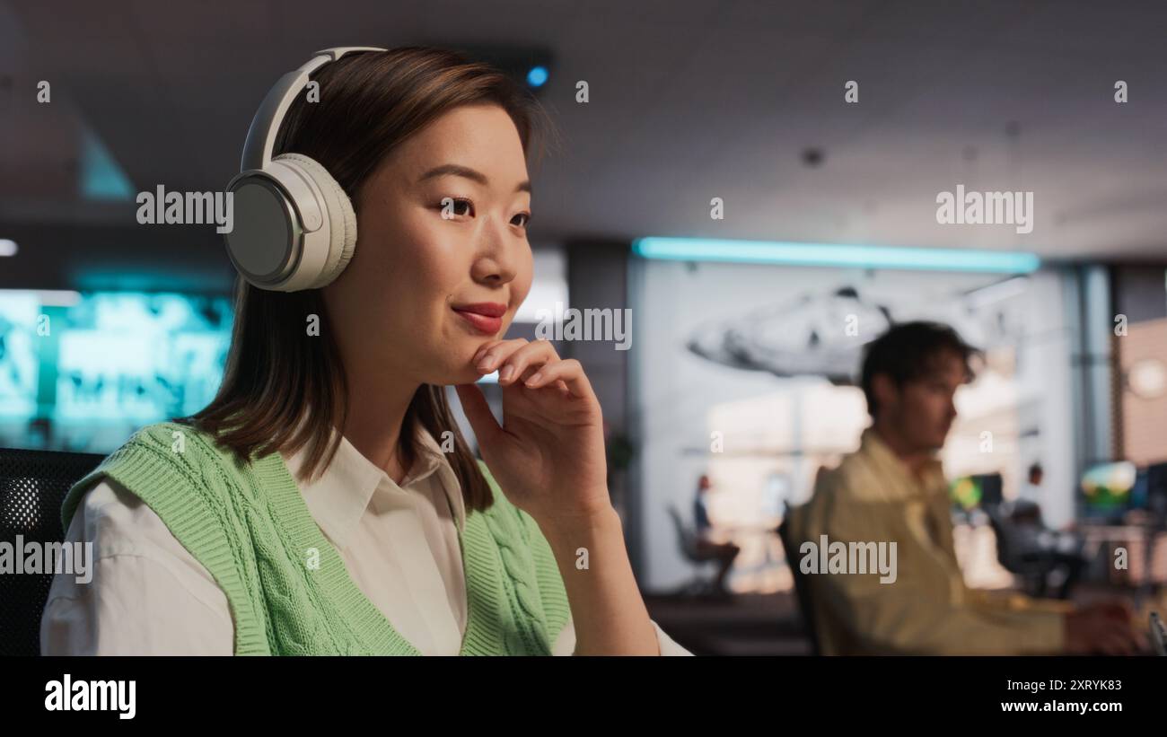 Female Asian Game Designer Using Desktop Computer Designing Unique World And Characters In 3d