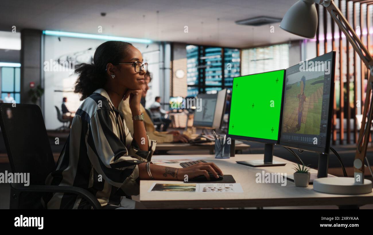 Female Black Game Designer Using Desktop Computer With Green Screen Chromakey on Display ...