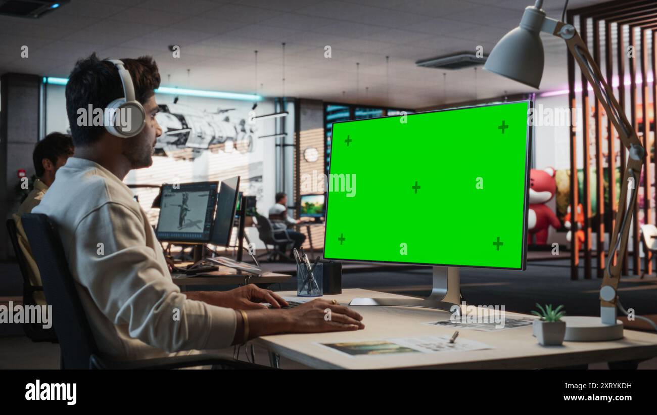 Indian Male Game Designer Using Desktop Computer With Green Screen Chromakey on Display ...
