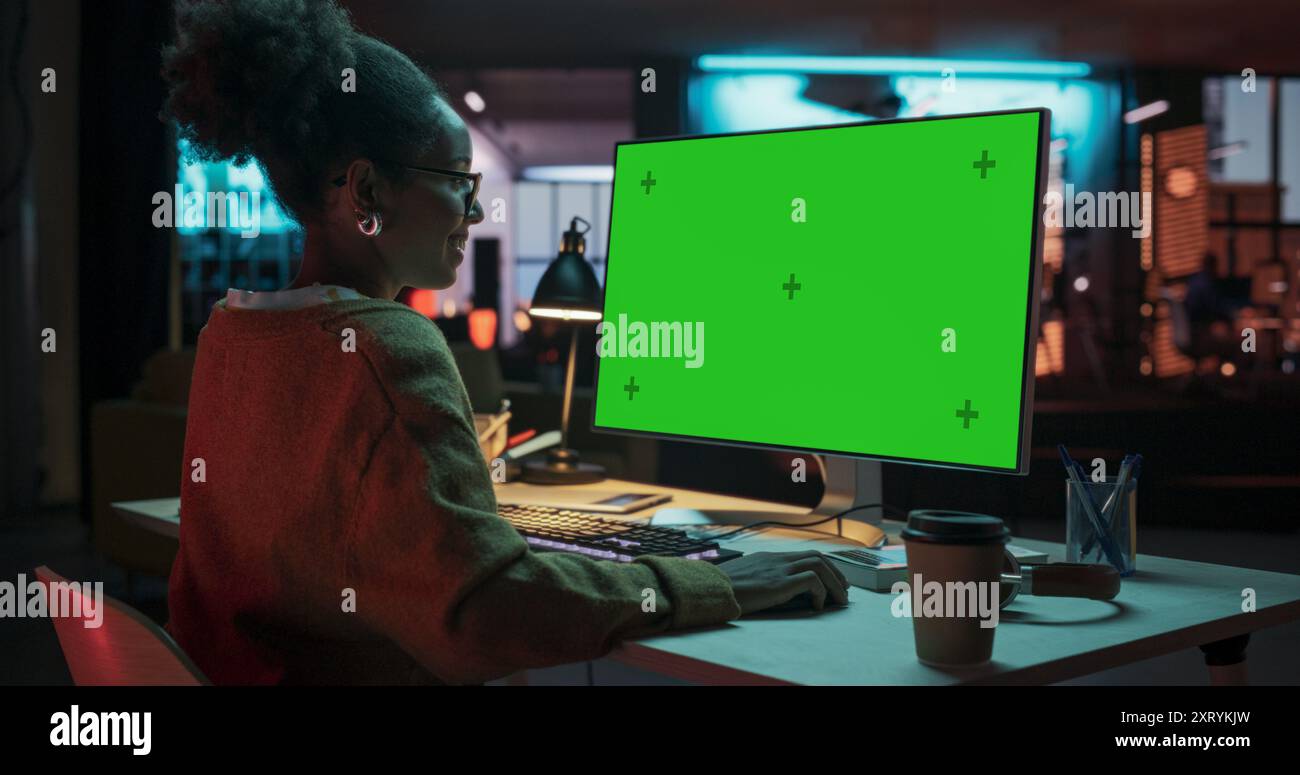Over the Shoulder: African Female Specialist Working on Computer with ...