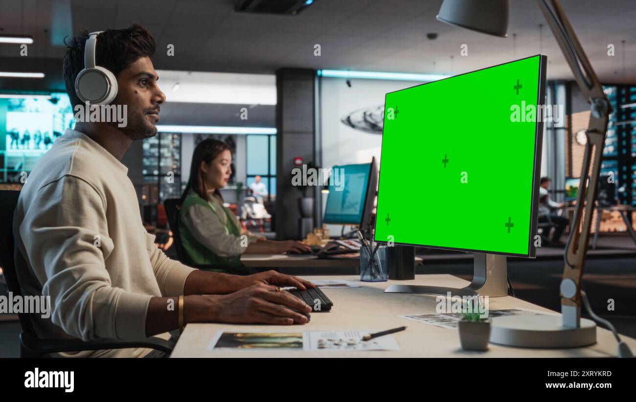 Indian Male Game Designer Using Desktop Computer With Green Screen ...