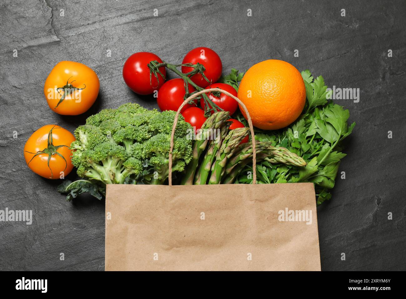 Vegan food delivery. Paper bag with different fresh vegetables and ...