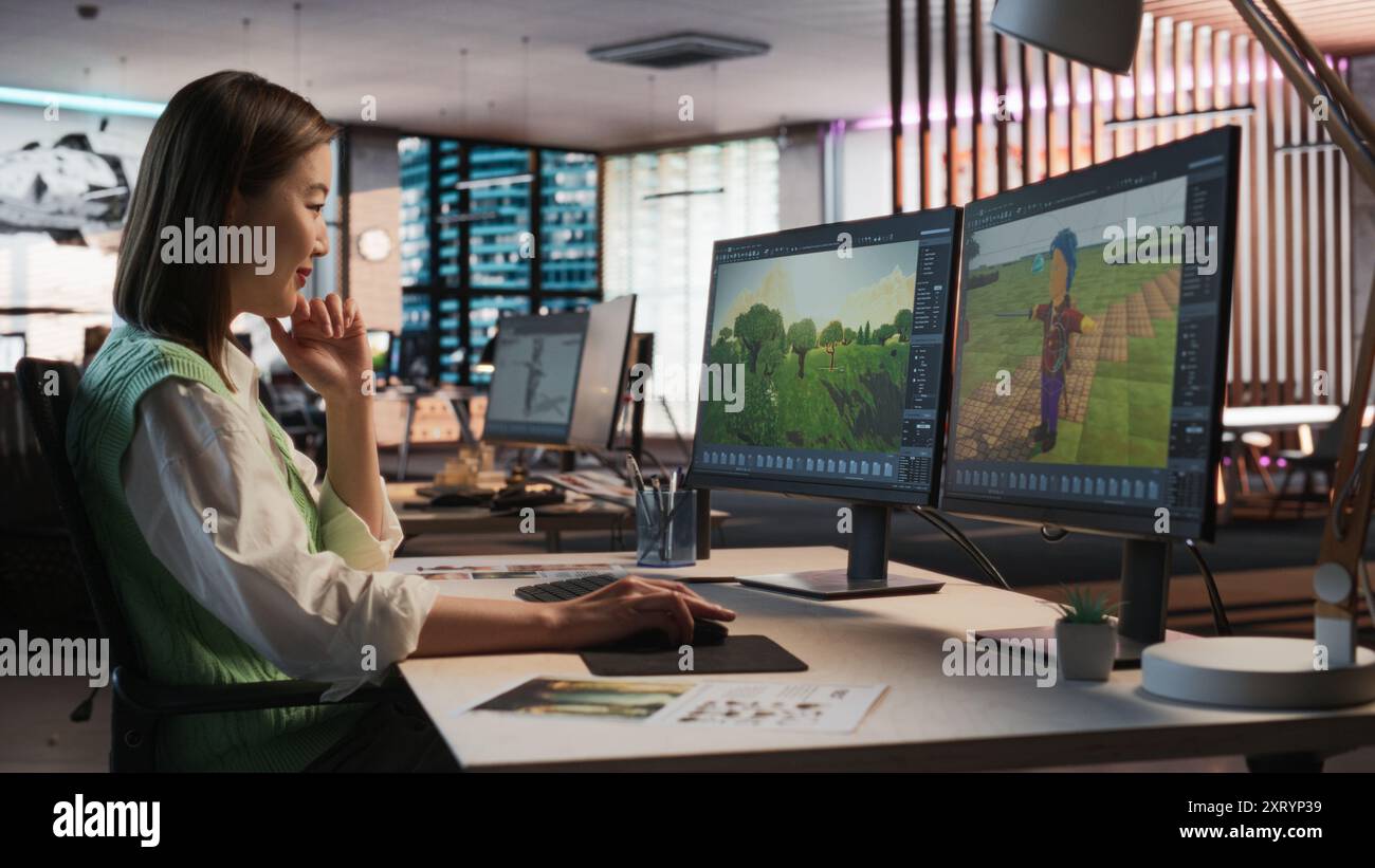 Female Asian Game Designer Using Desktop Computer Designing Unique World And Characters In 3d