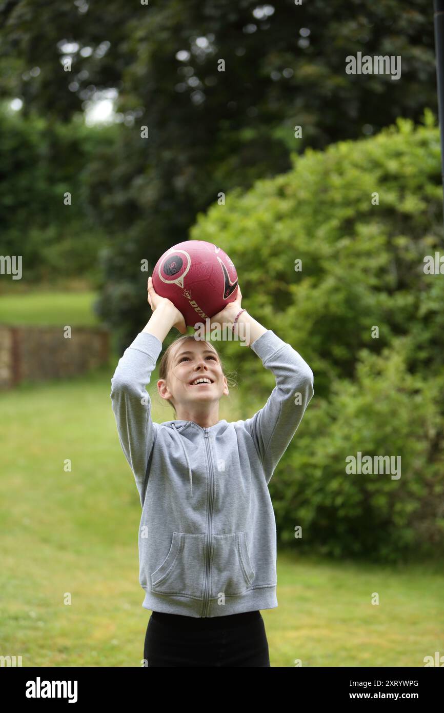 Girl playing netball practising shooting - sport aiming aim accuracy ...