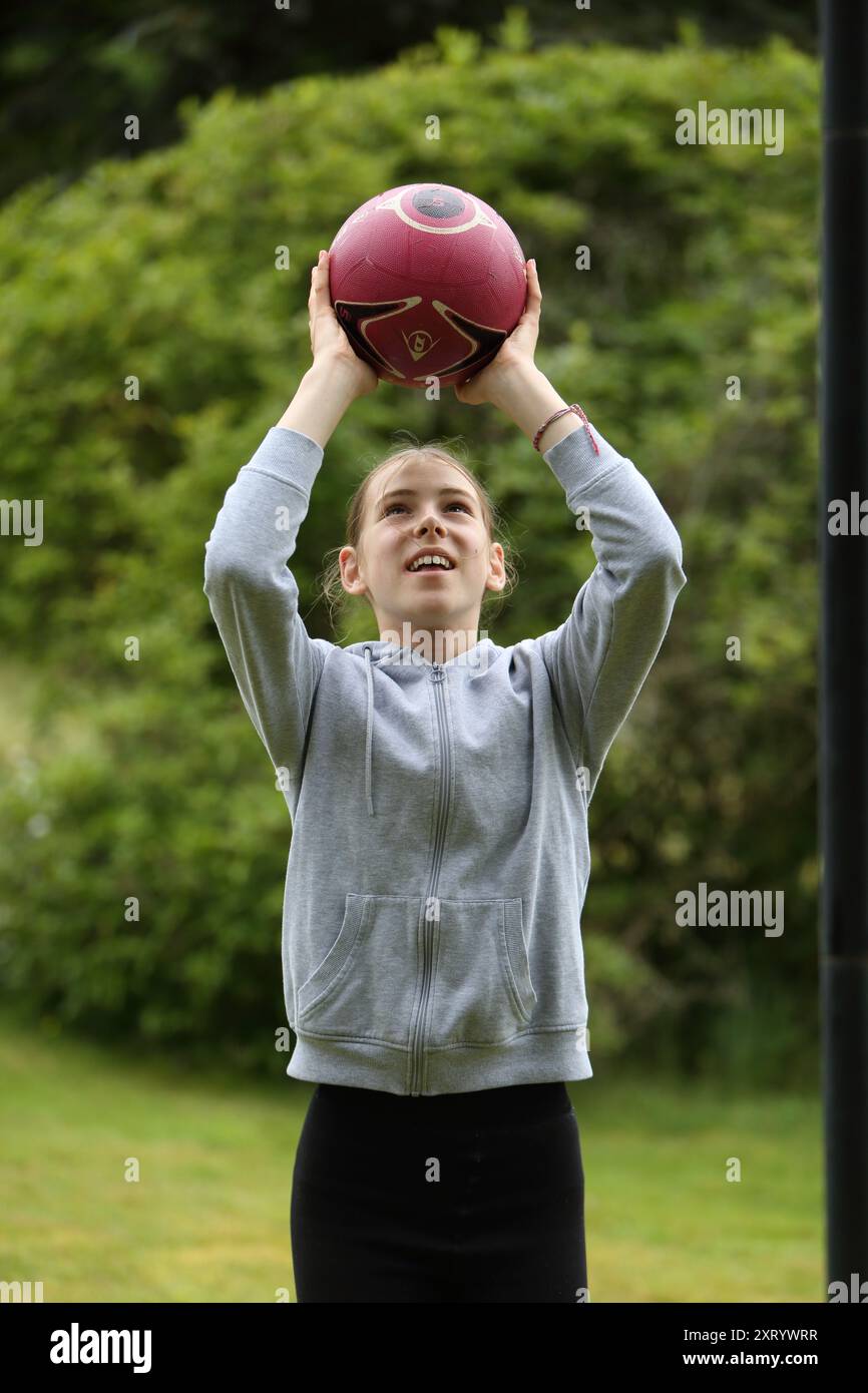 Girl playing netball practising shooting - sport aiming aim accuracy ...