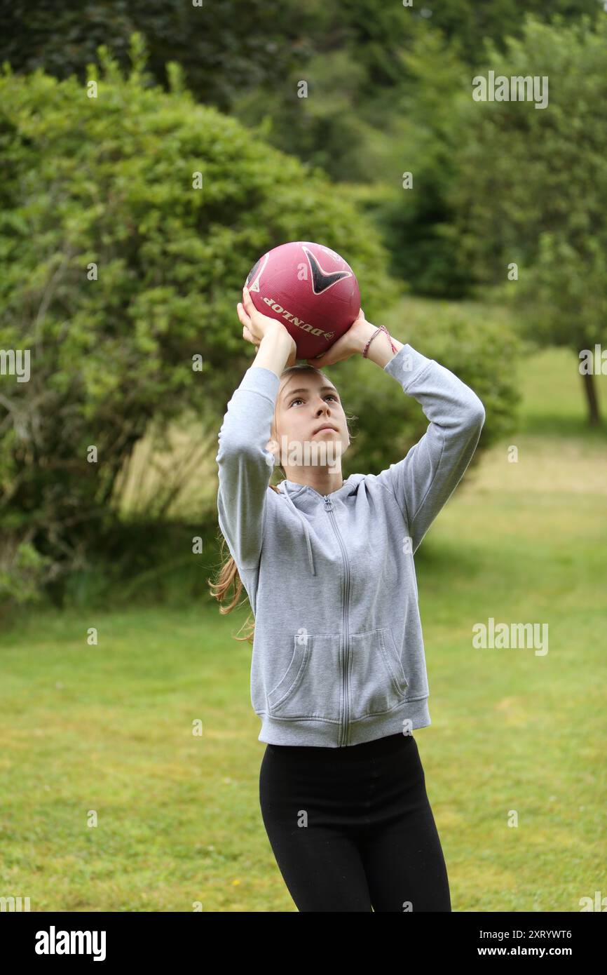 Girl playing netball practising shooting - sport aiming aim accuracy ...