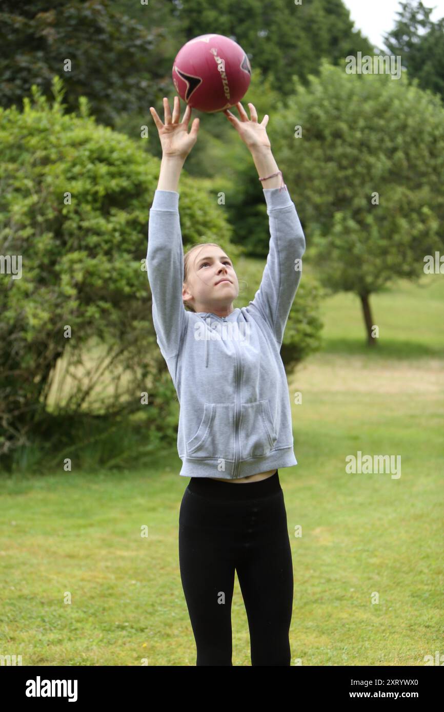 Girl playing netball practising shooting - sport aiming aim accuracy ...