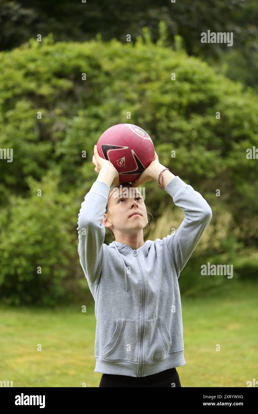 Girl playing netball practising shooting - sport aiming aim accuracy ...