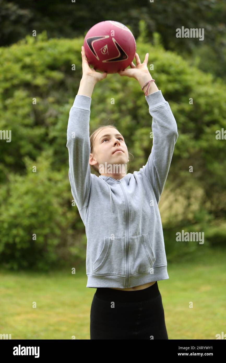 Girl playing netball practising shooting - sport aiming aim accuracy ...
