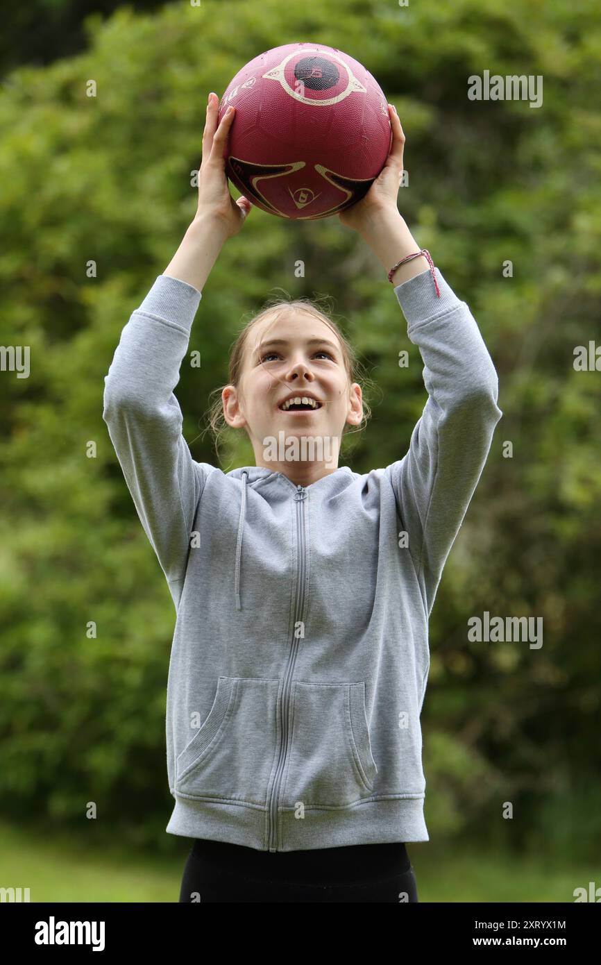 Girl playing netball practising shooting - sport aiming aim accuracy ...
