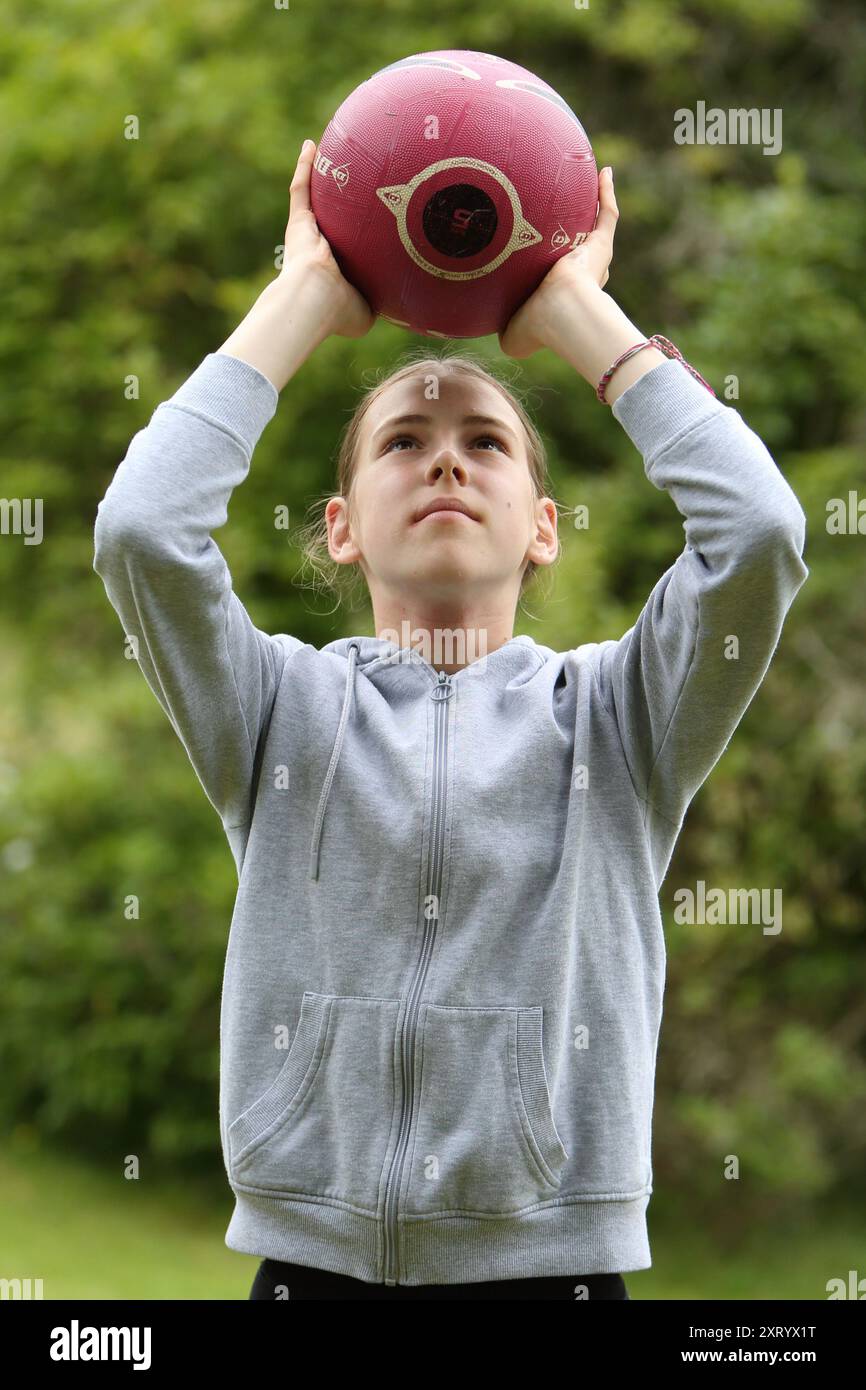 Girl playing netball practising shooting - sport aiming aim accuracy ...