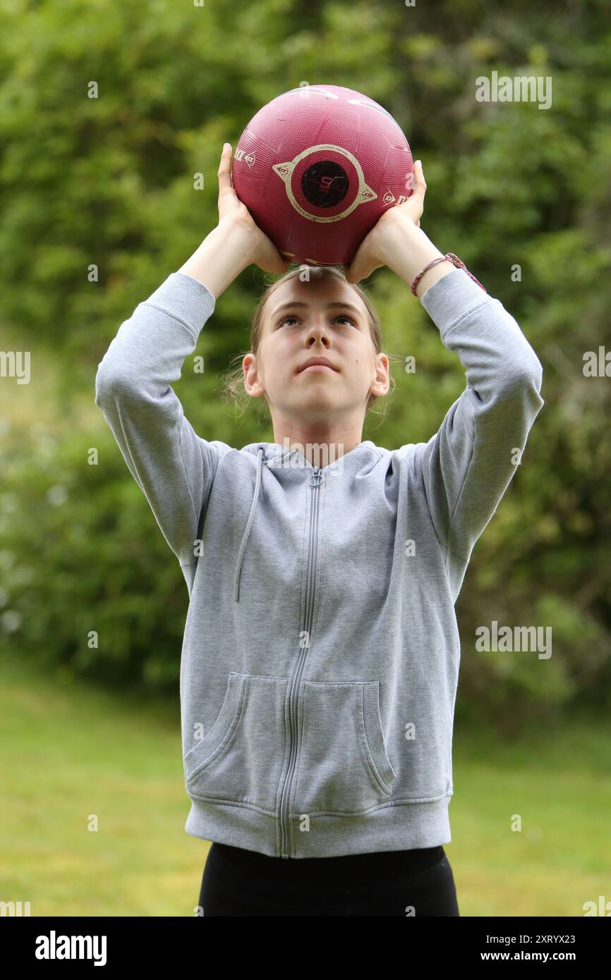 Girl playing netball practising shooting - sport aiming aim accuracy ...