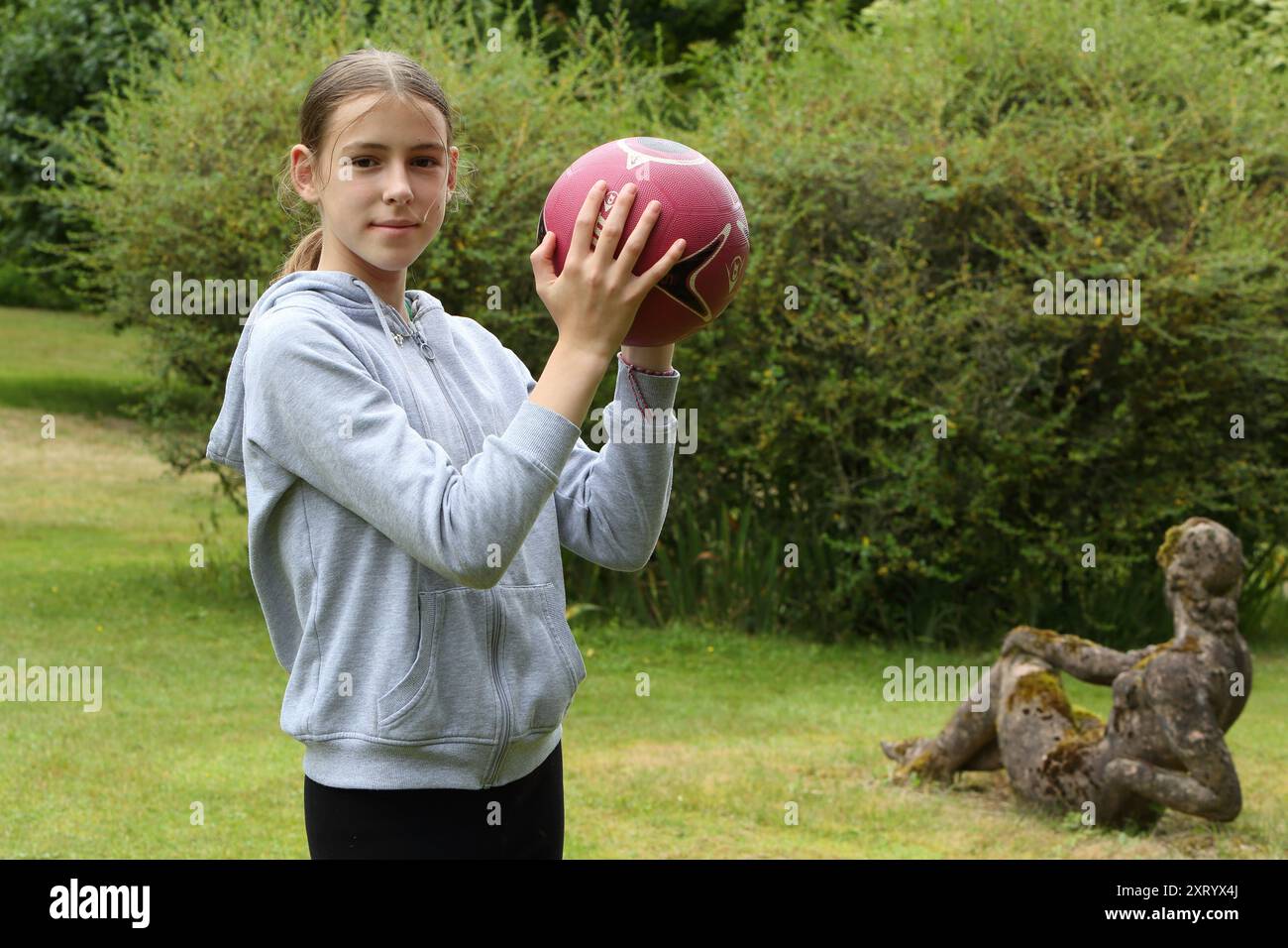 Girl playing netball holding netball - sport Stock Photo - Alamy