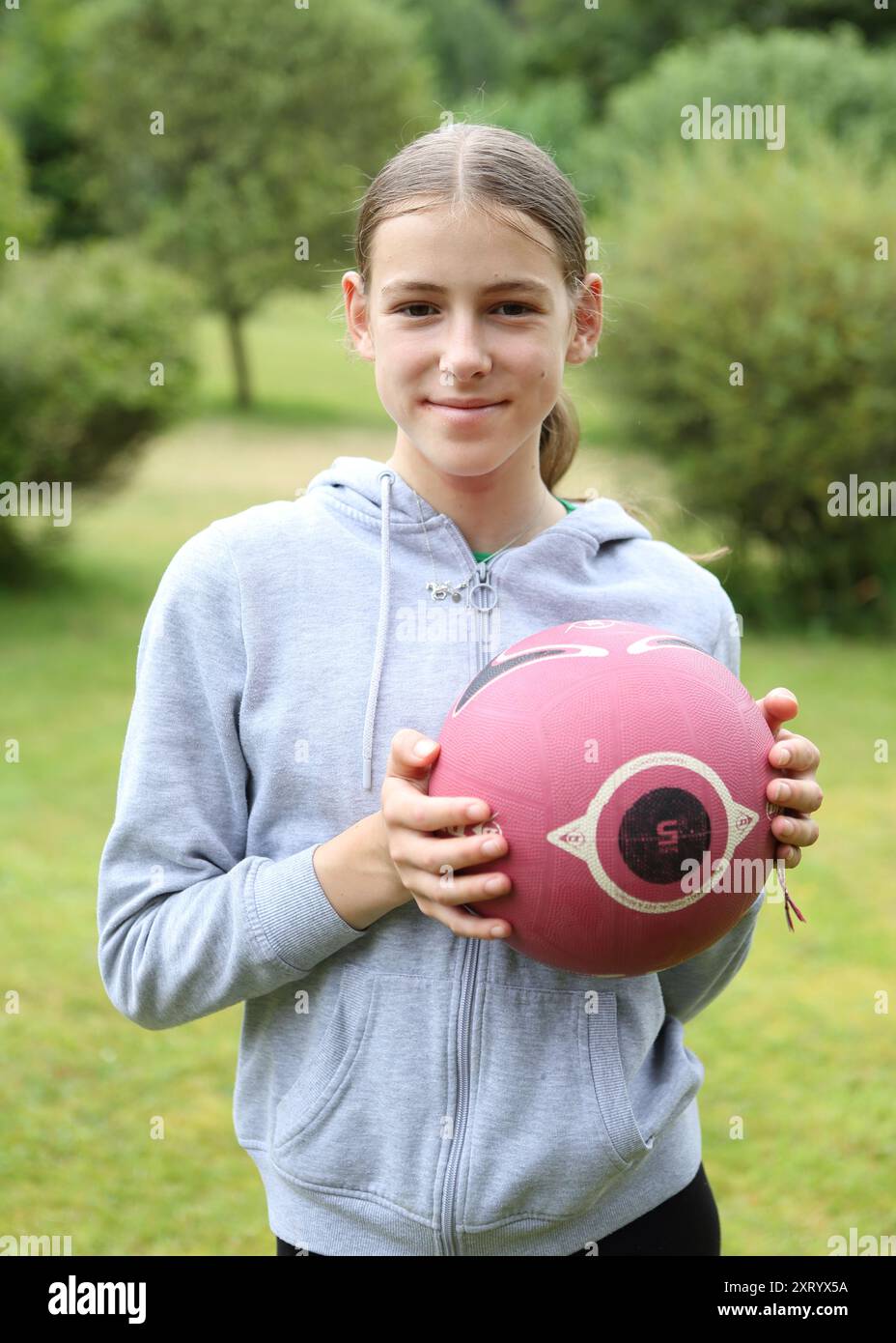 Girl playing netball holding netball smiling - sport exercise teenage ...