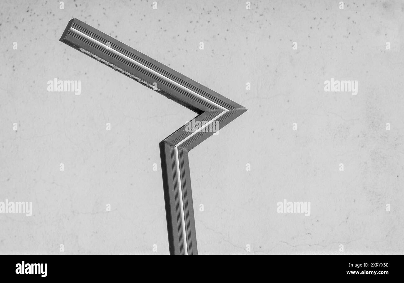 Modern Light Post in Arrow Shape: Guiding Direction Against a Stone ...