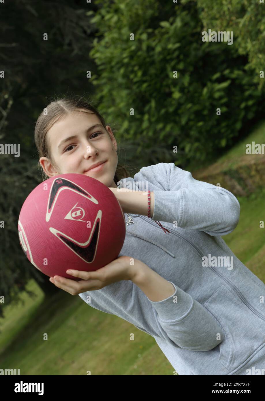 Girl playing netball holding netball smiling - sport exercise teenage ...