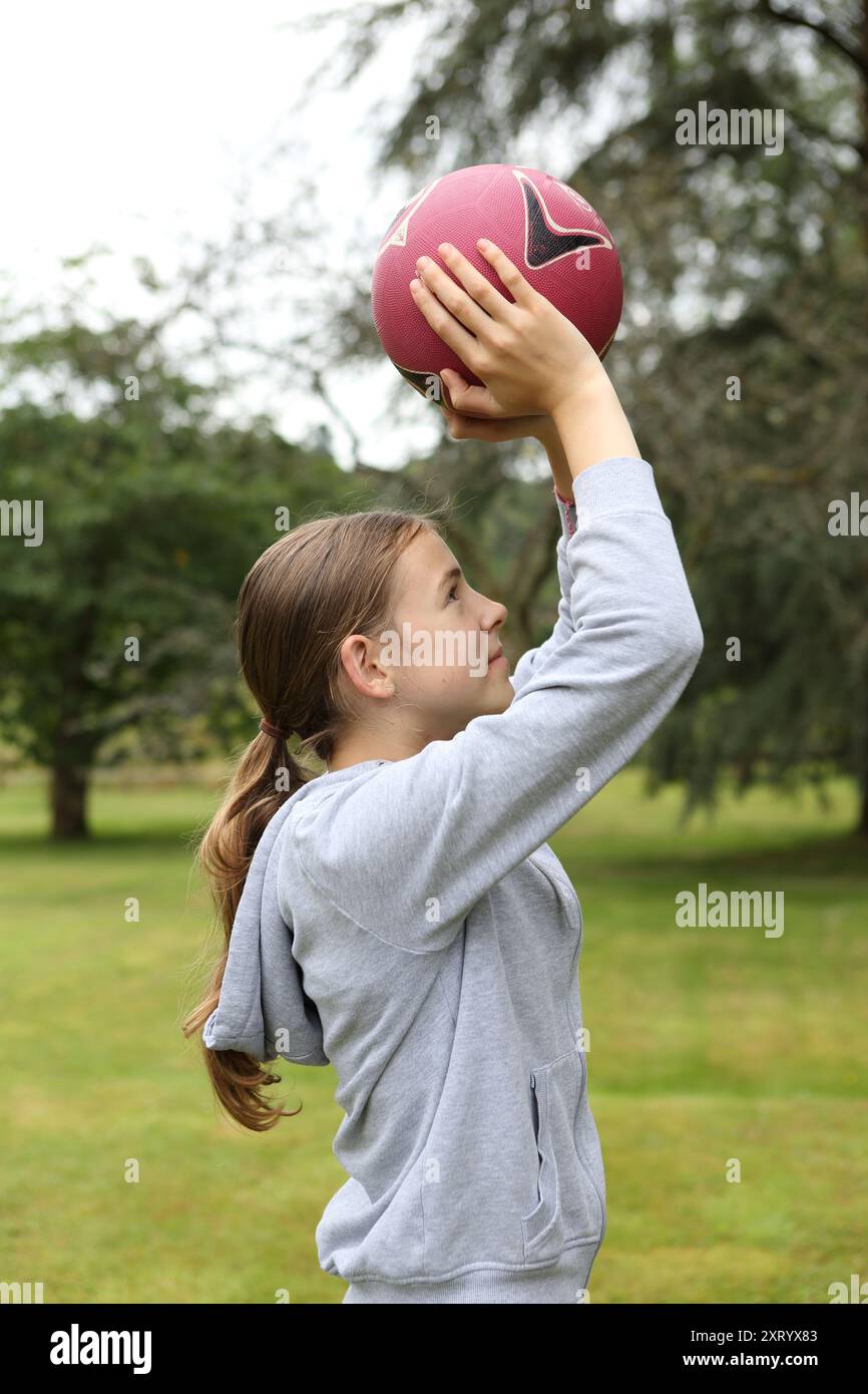 Girl playing netball practising shooting - sport aiming aim accuracy ...