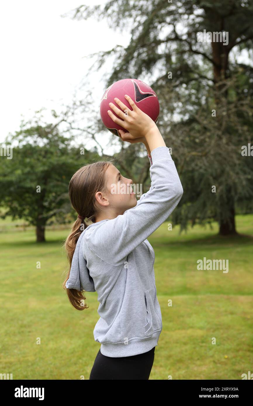 Girl playing netball practising shooting - sport aiming aim accuracy ...