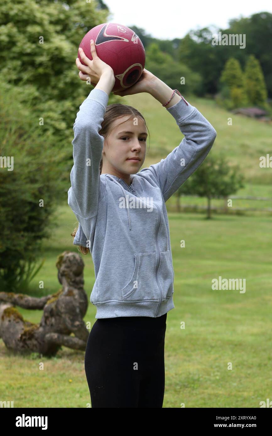 Girl playing netball practising shooting - sport aiming aim accuracy ...