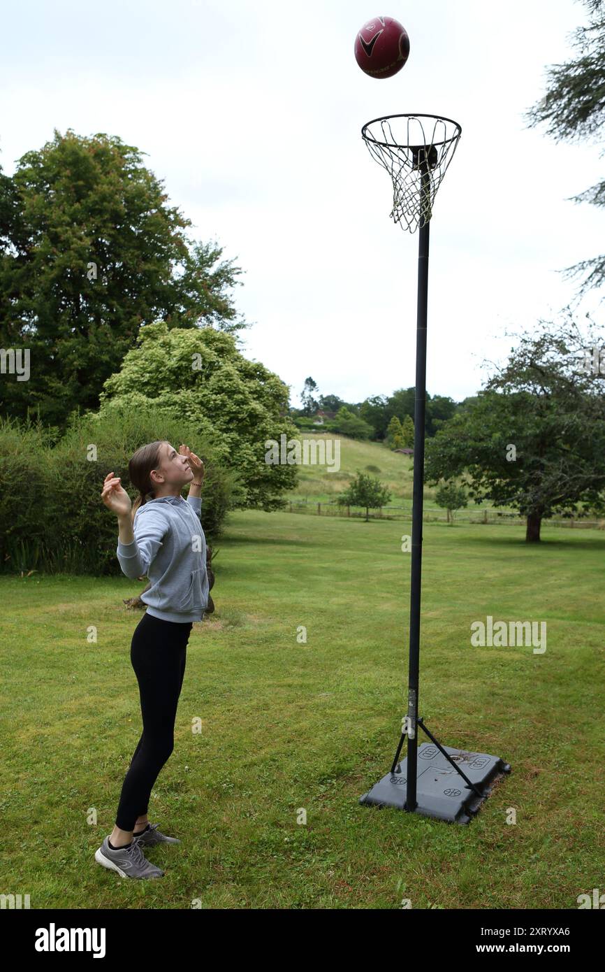 Girl playing netball practising shooting - sport aiming aim accuracy ...