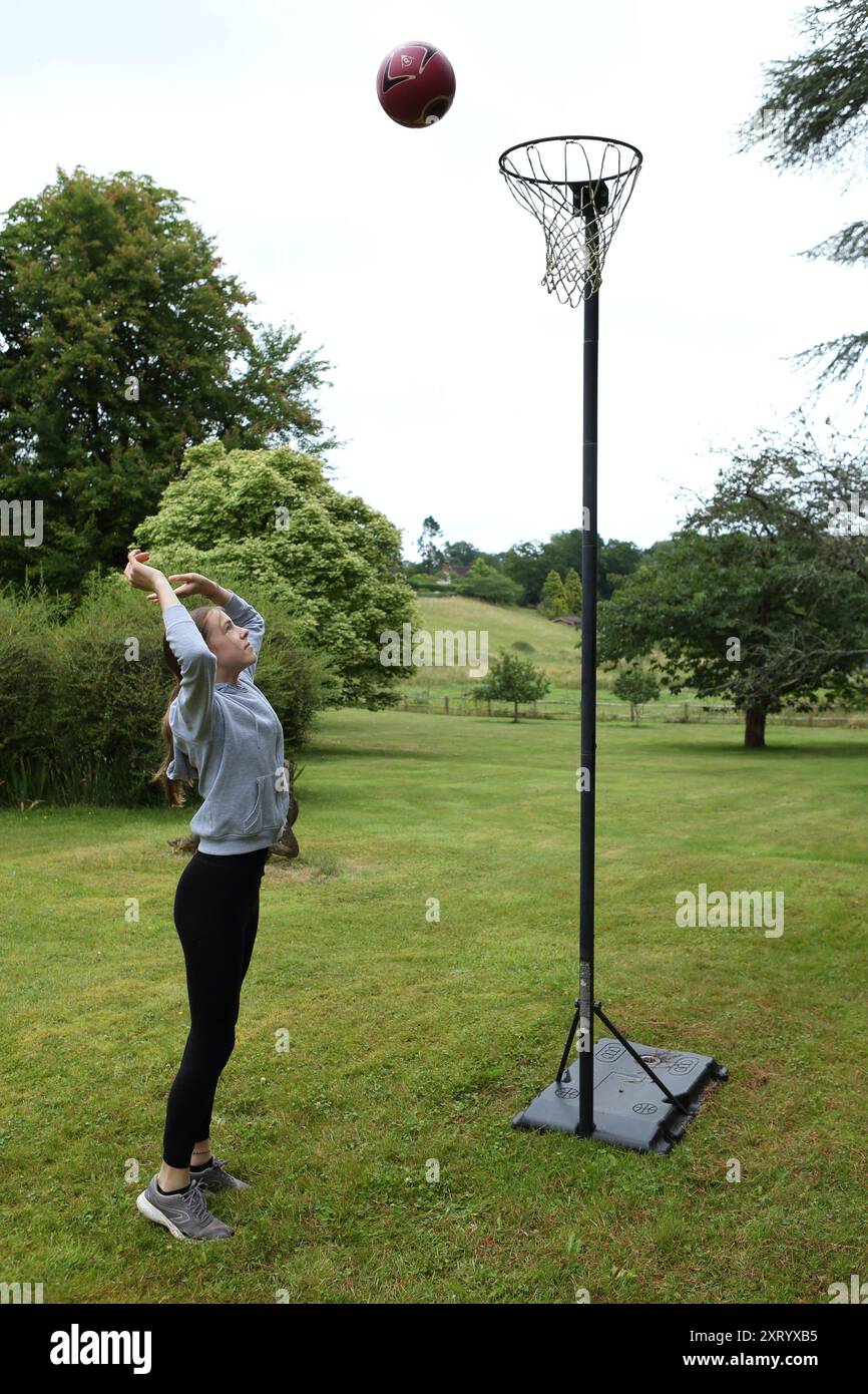 Girl playing netball practising shooting - sport aiming aim accuracy ...